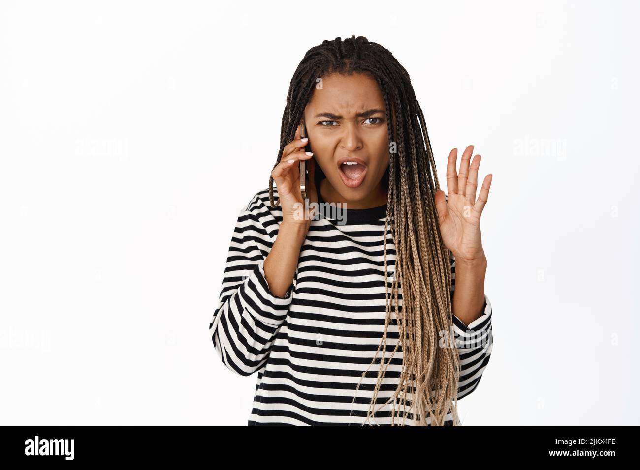 Shocked black woman answer phone call, talking on mobile with ...