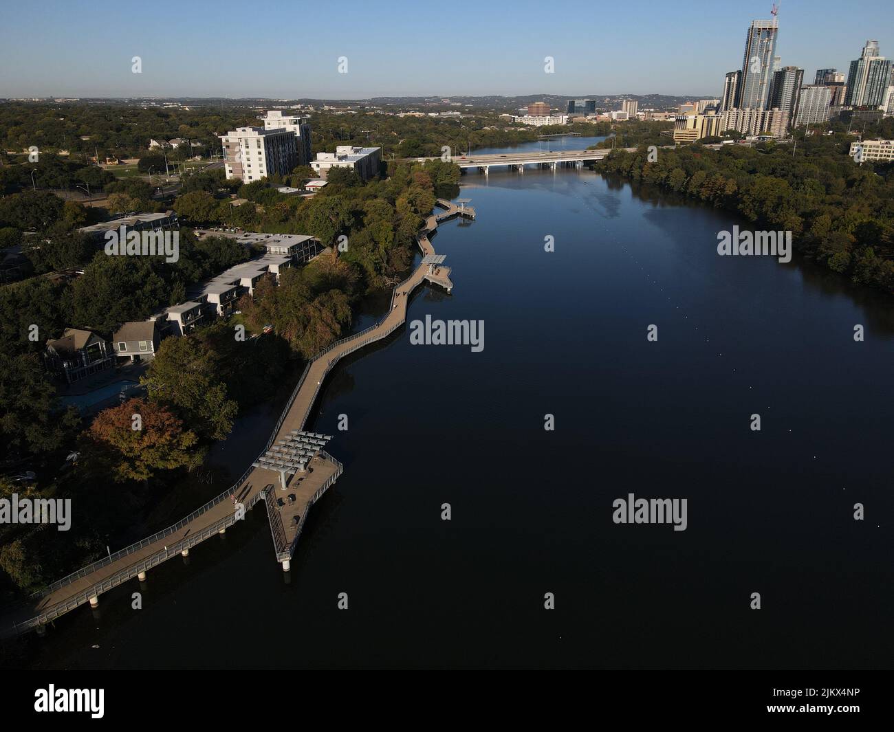 An aerial shot of a bridge above a river flowing through its banks ...