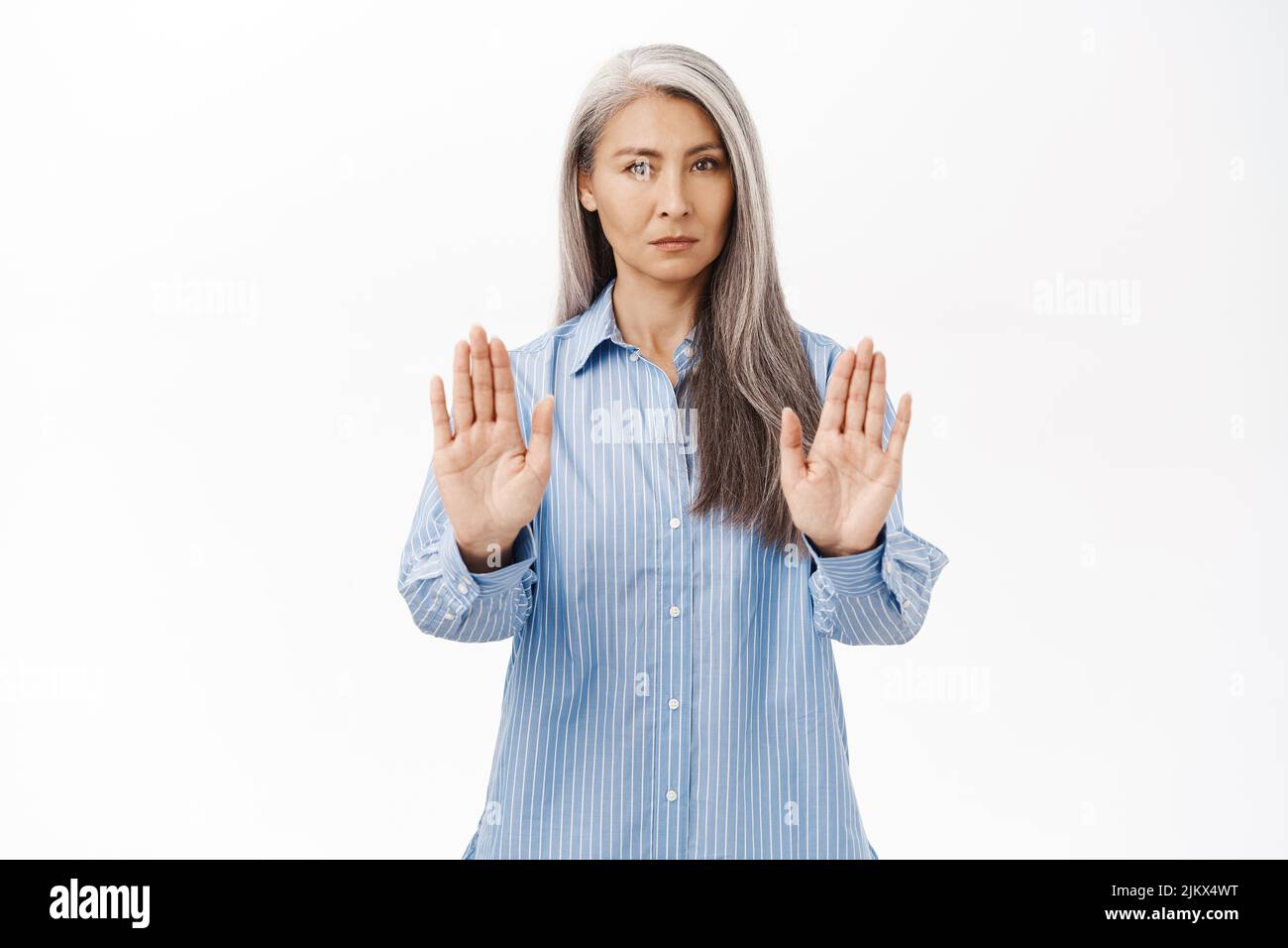 Stop. Serious asian woman showing prohibit, forbid gesture, extending ...