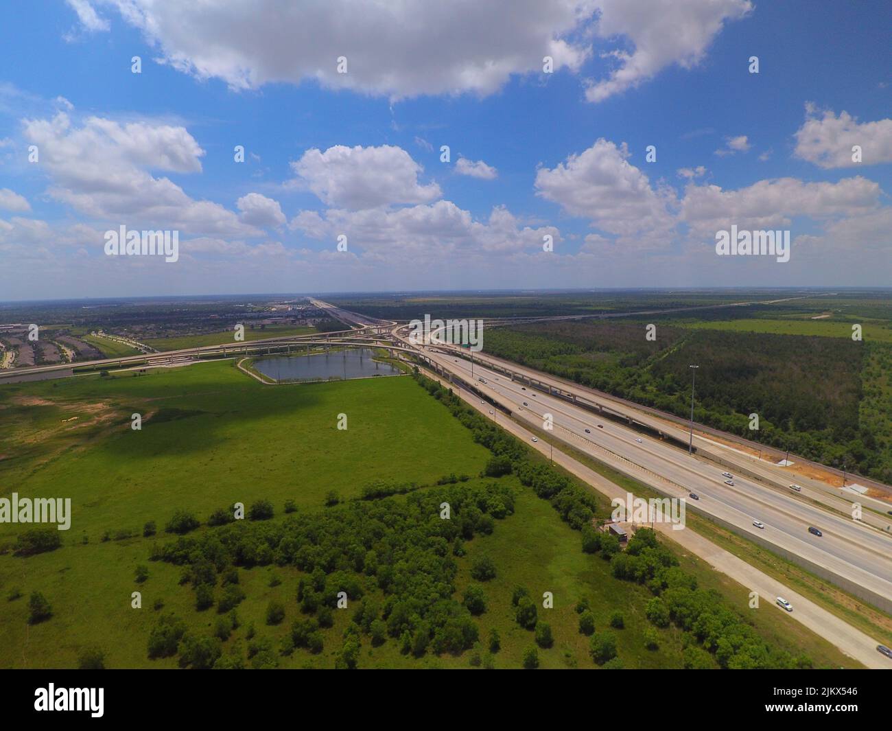 An aerial shot of a bridge above a river flowing through its banks ...