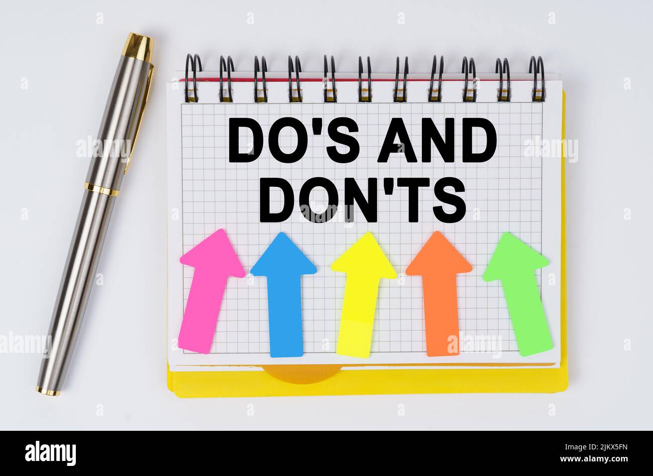 Business and finance concept. On a white background lie a pen and a notebook with the ...