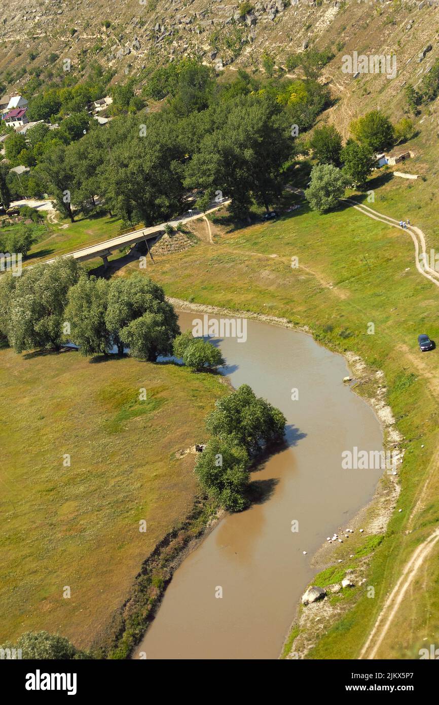 Beautiful natural gorge strewn with hills, grass and trees. At bottom ...