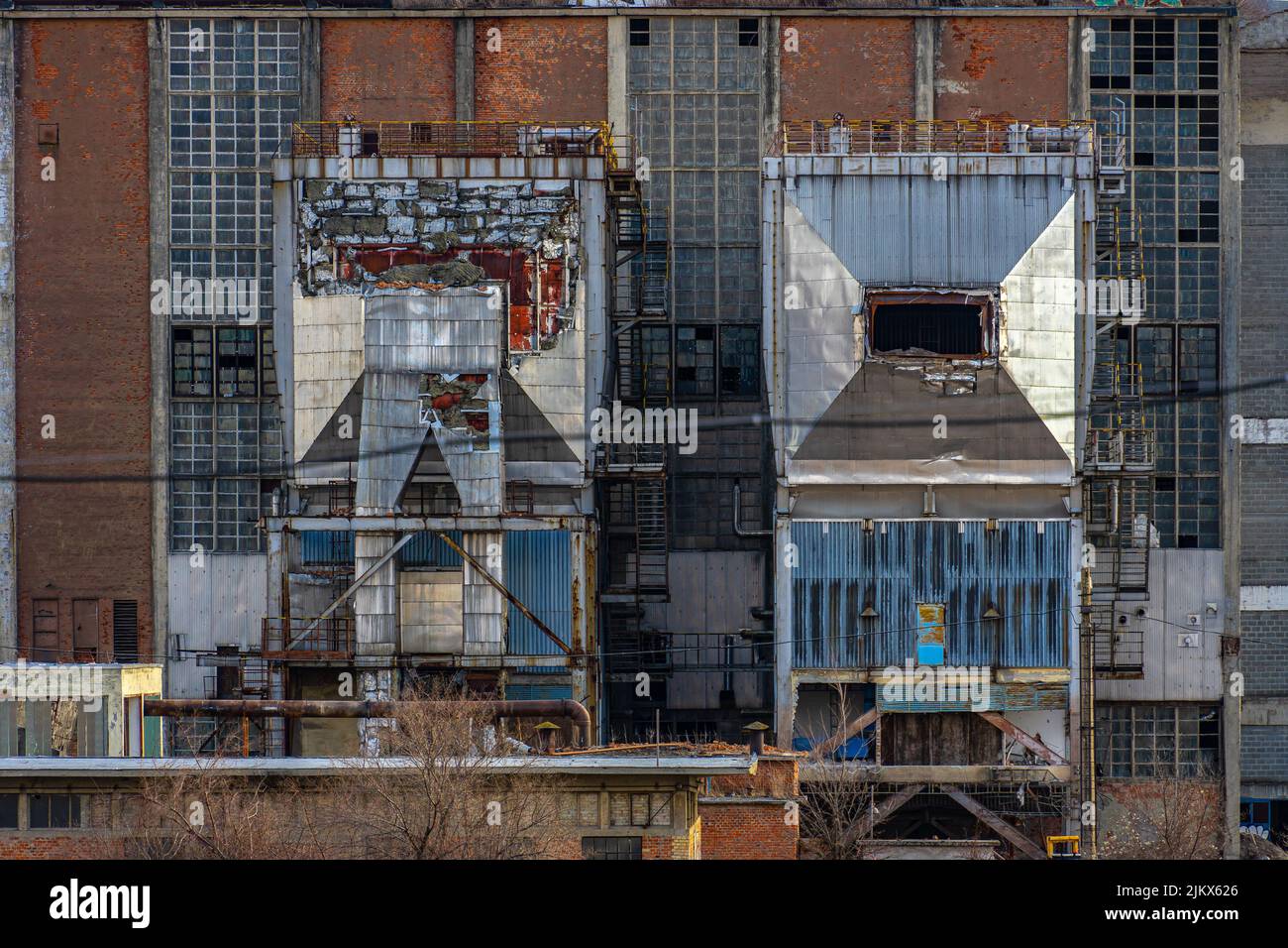 Rusty facade with waste disposer on the main building of abandoned ...