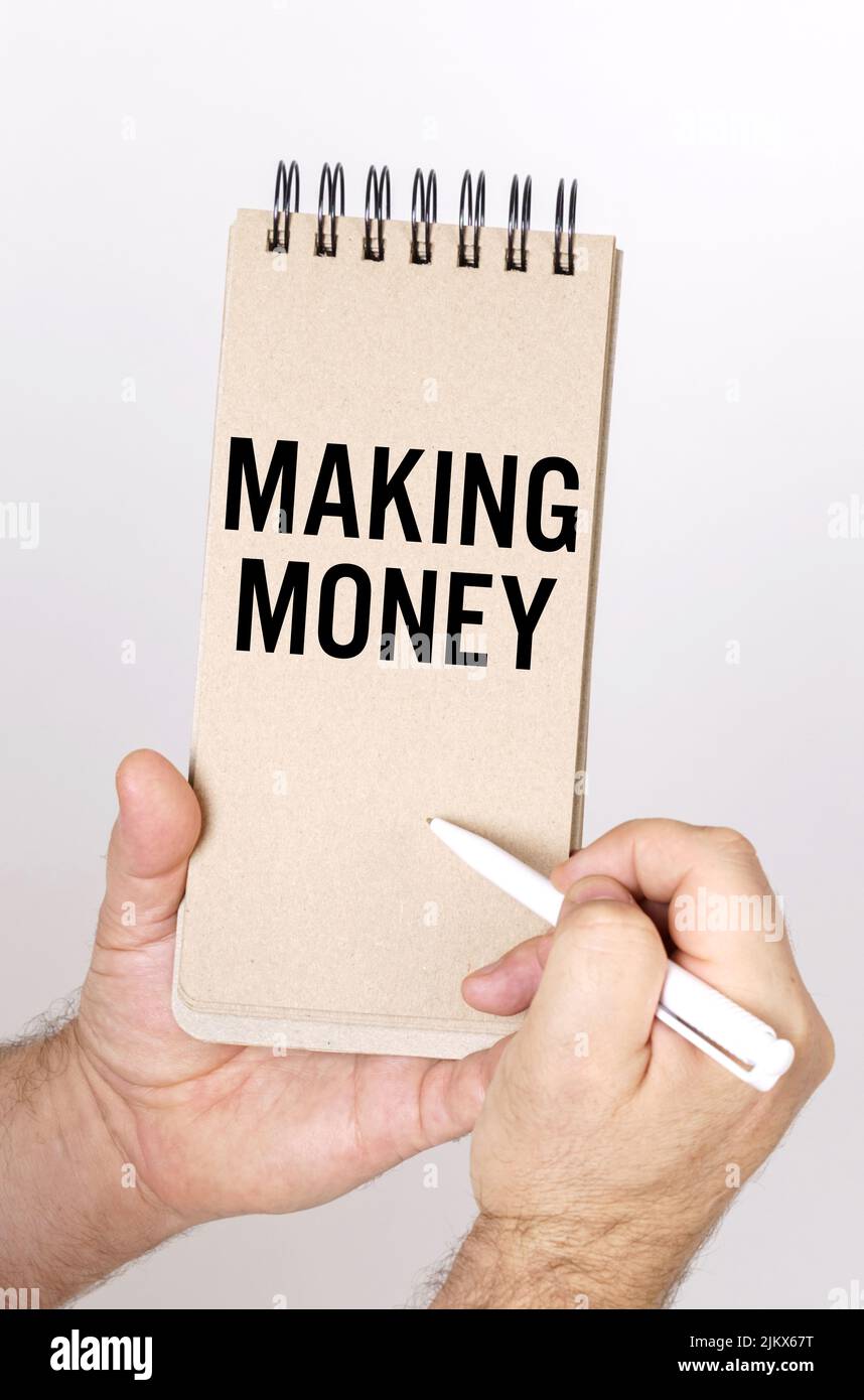 Business and finance concept. A man holds a pen and a bolknot in his ...