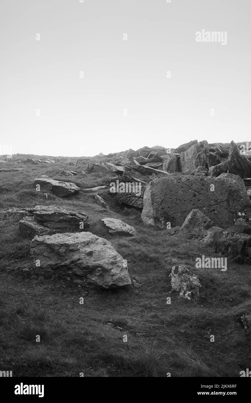 black and white monochrome View over rocks and grass on a grey rainy ...