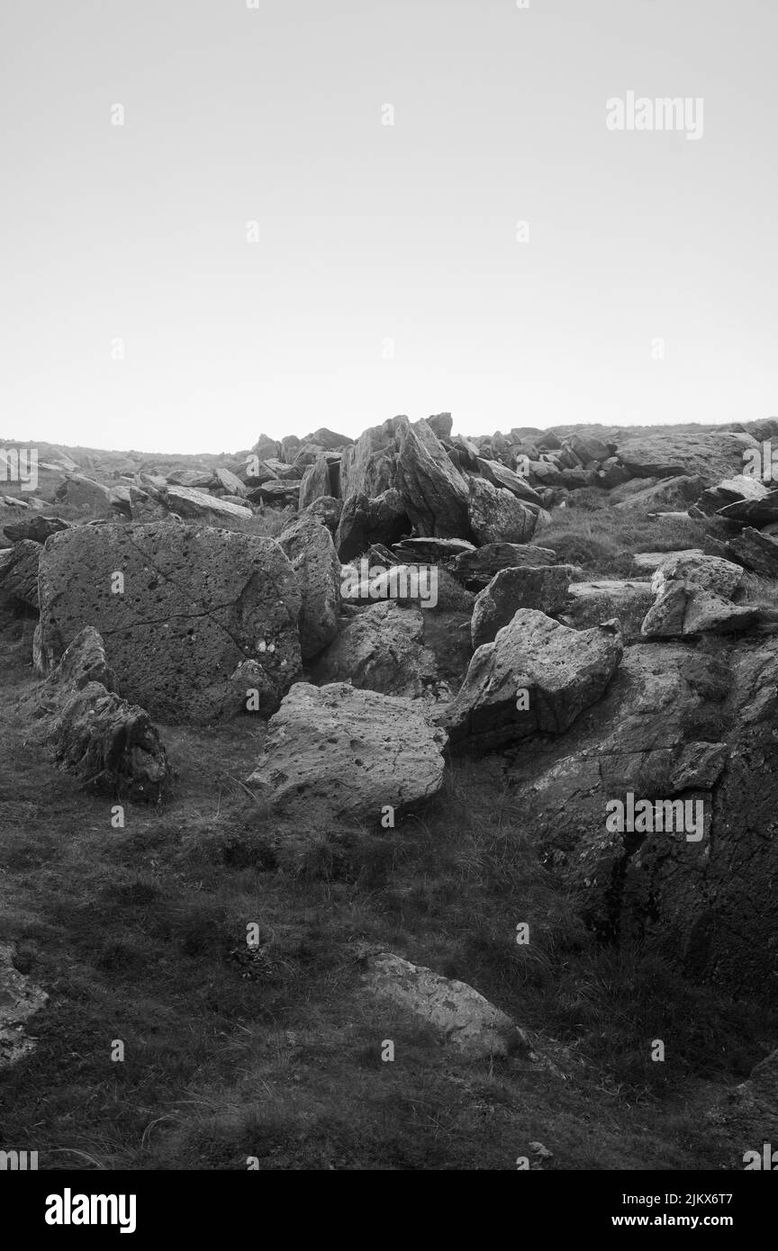 black and white monochrome View over rocks and grass on a grey rainy ...
