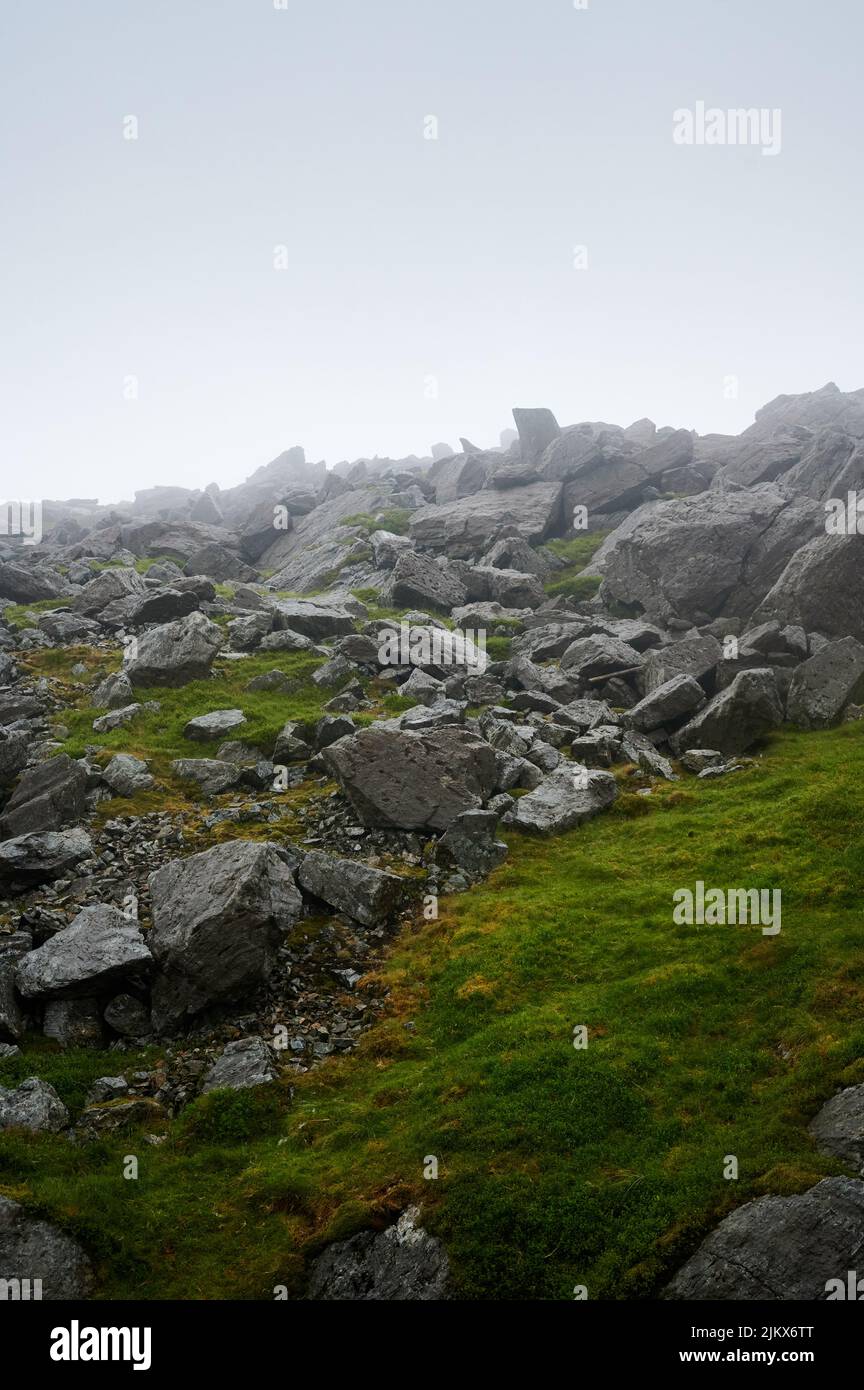 View over rocks and grass on a grey rainy day on hillside in wales, UK ...