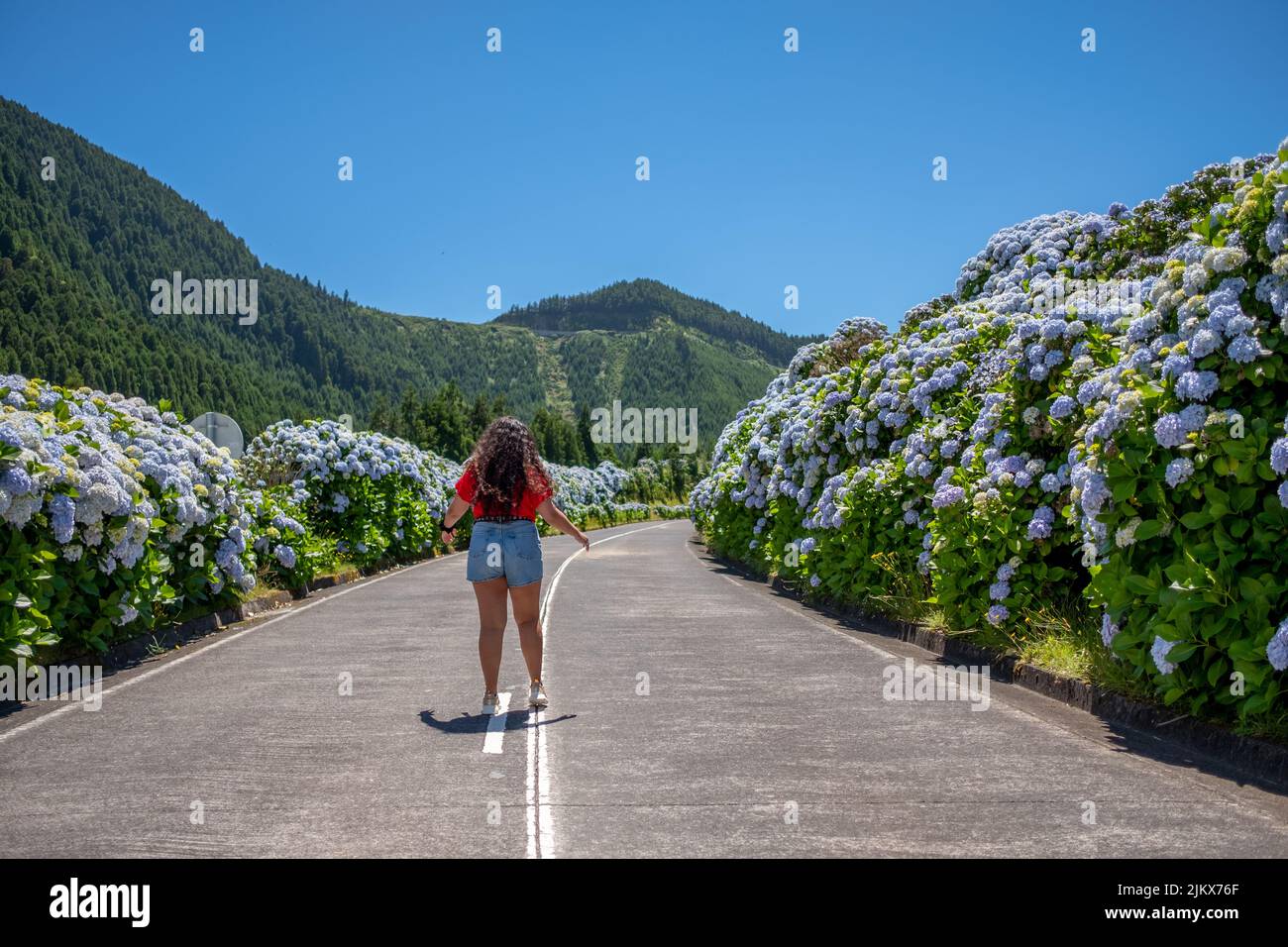Azores, long hair azorean young girl happy walking in the middle of ...