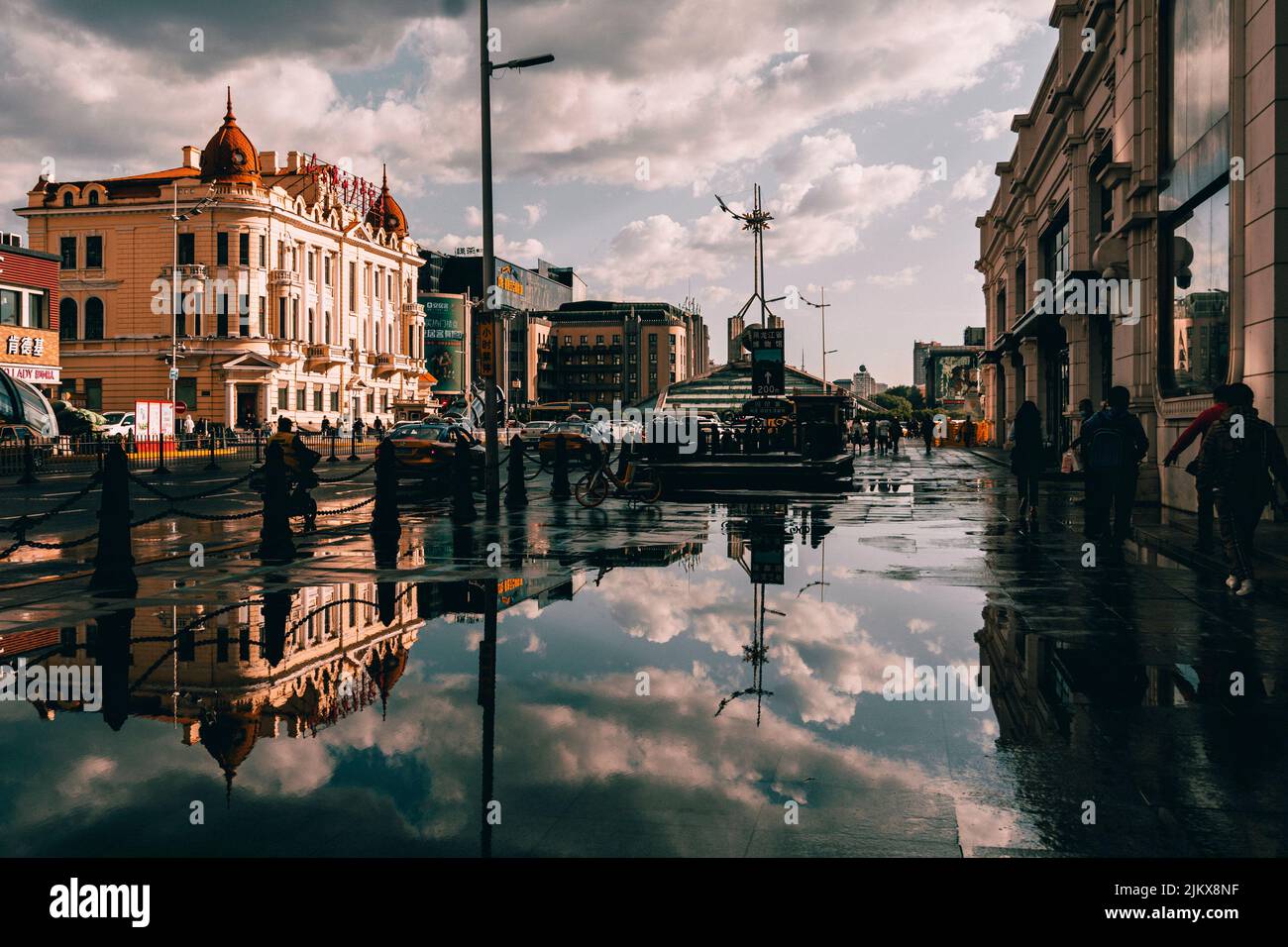 A beautiful shot of city buildings reflecting on the ground after the ...