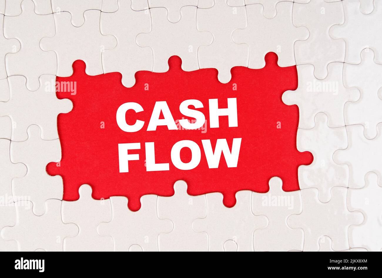 Business and finance concept. In the middle of the puzzles on a red ...