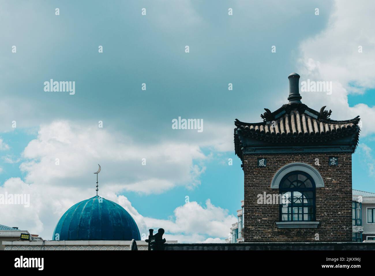 A view of an ancient Asian building and a temple dome against the ...