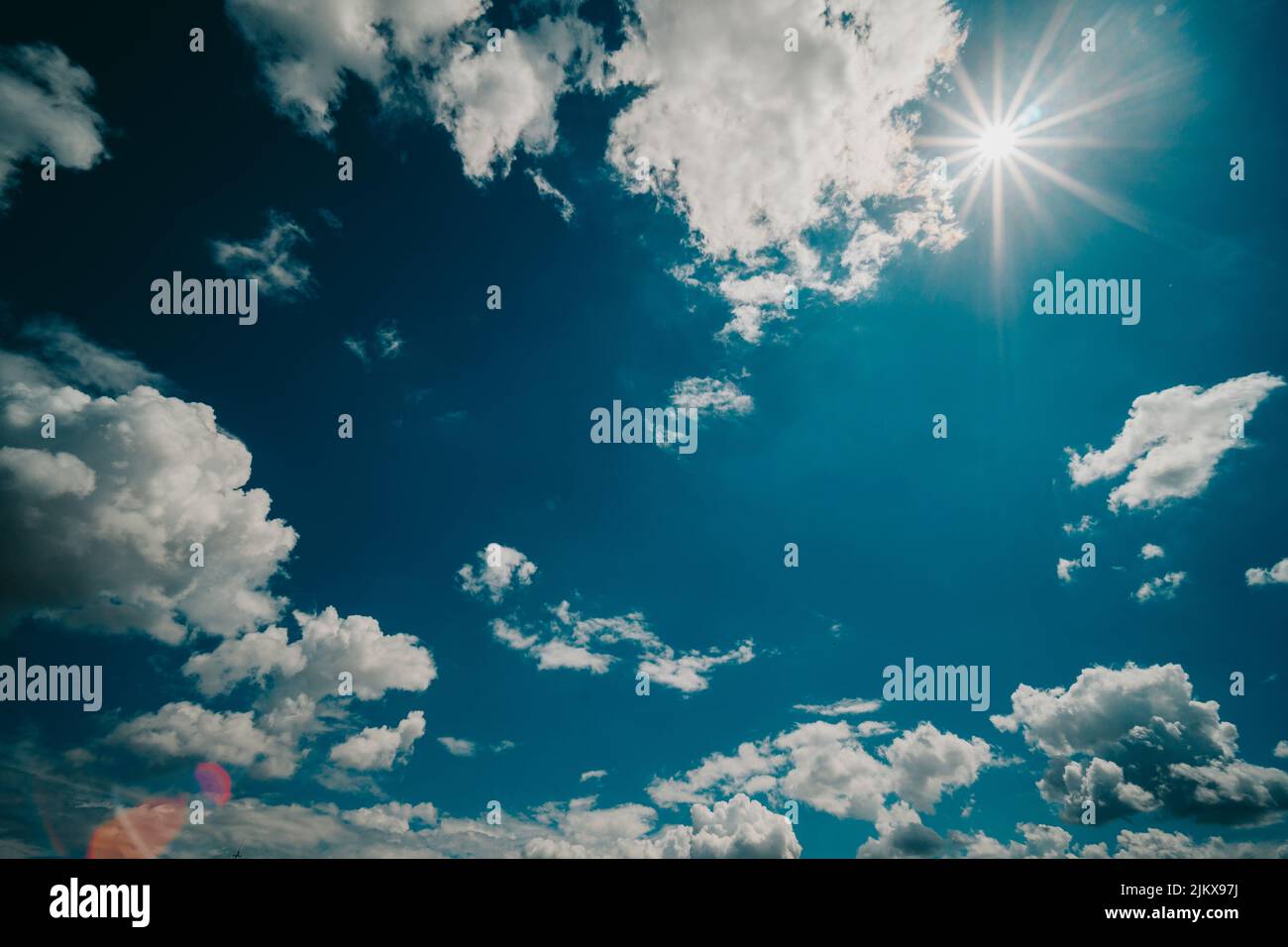 A sunny morning with the shining sun and white clouds Stock Photo - Alamy