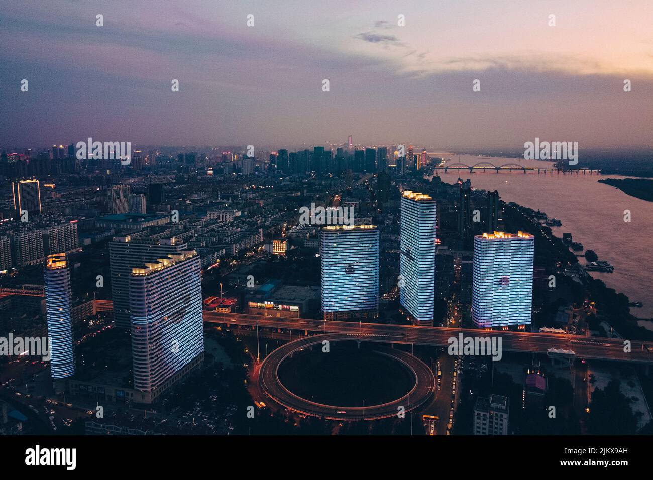 An aerial view of an illuminated modern city in the evening Stock Photo ...