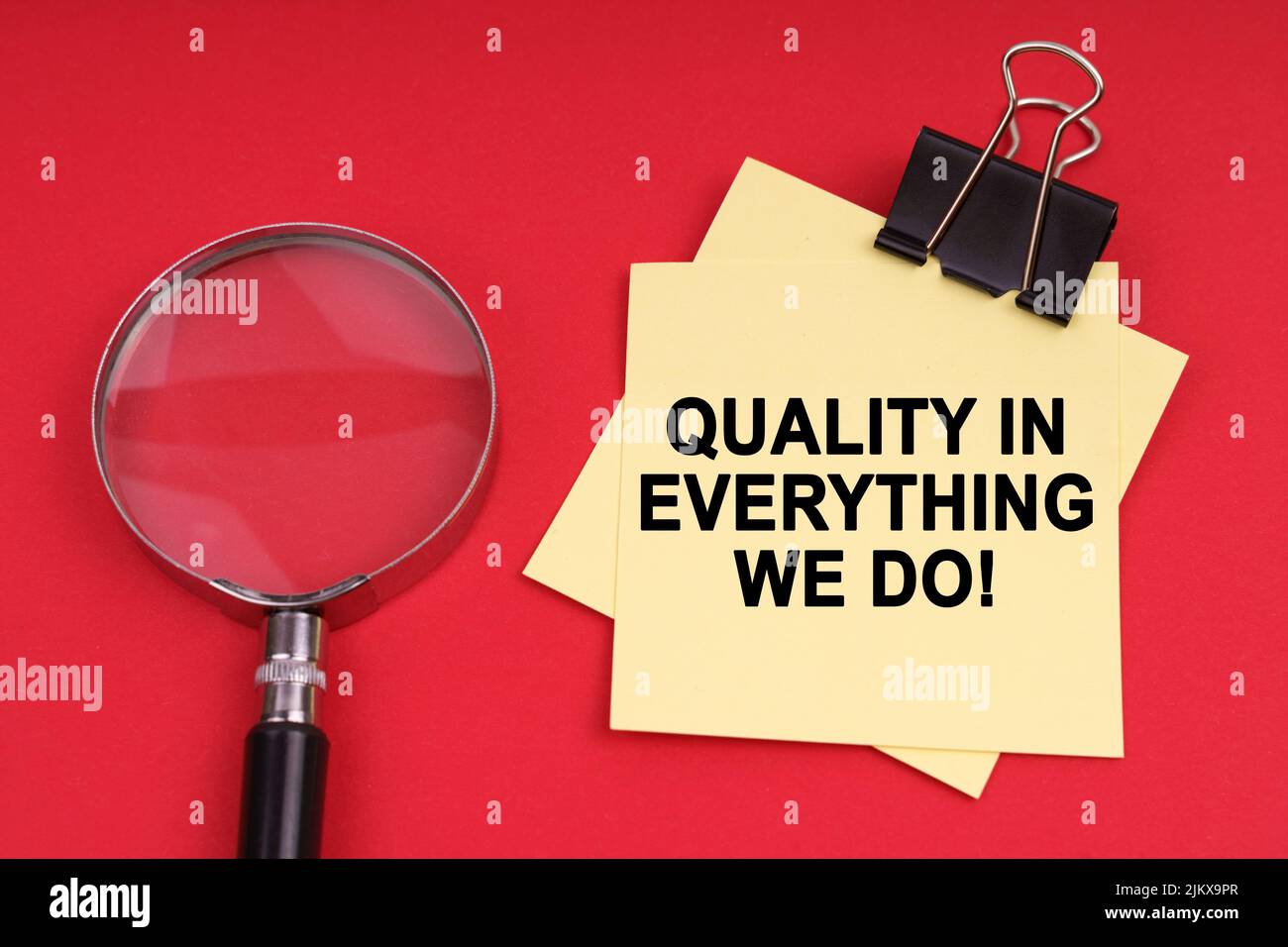 Business and Economics. On a red background, a magnifying glass and a ...