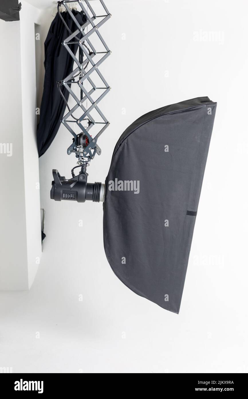 A vertical closeup of a constant light stand against a white background ...