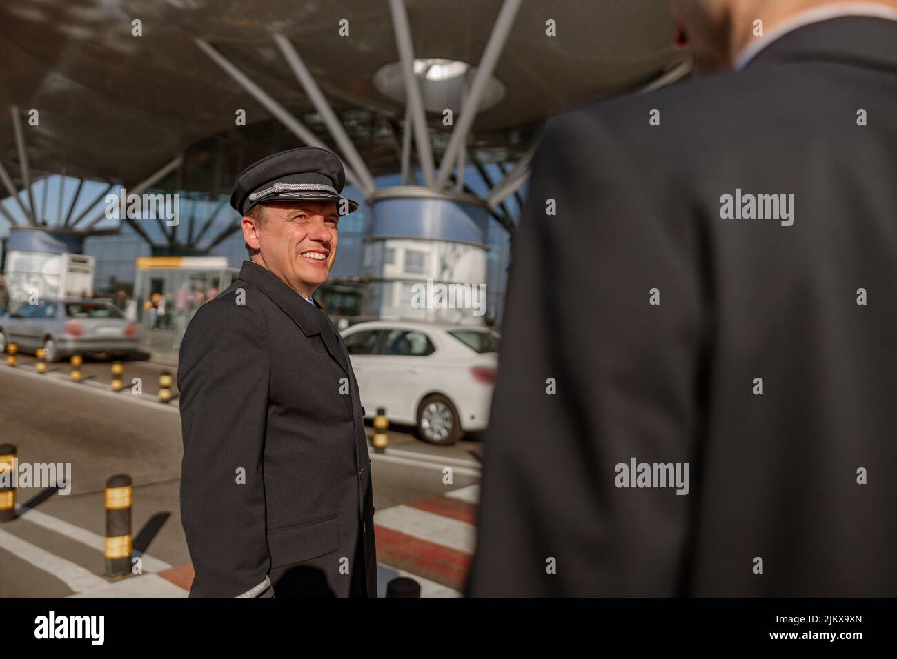 Two pilots talking near the terminal outdoor Stock Photo - Alamy