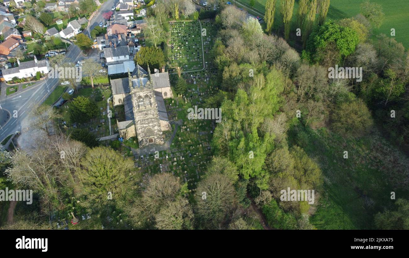 A bird's eye view of a small-town church ad cemetery surrounded by ...