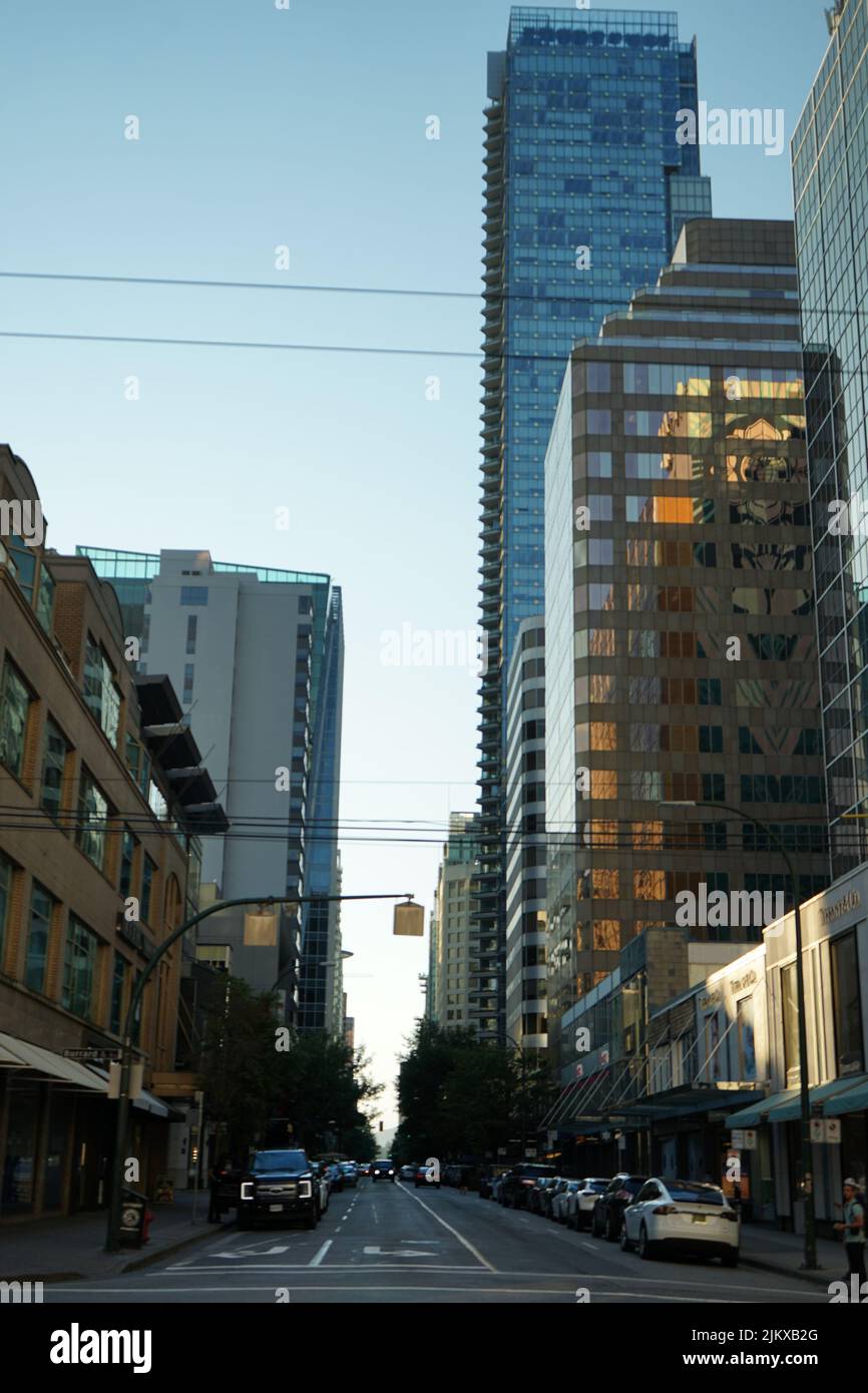 A vertical low angle view of tall skyscrapers above the street with ...