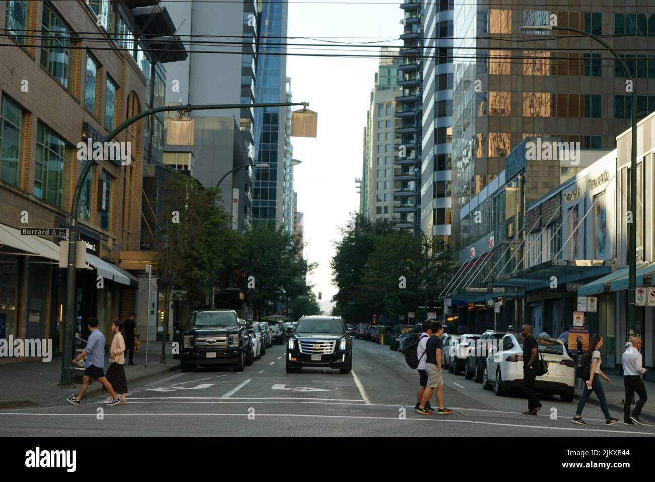 A View Of A Busy Street In Downtown Vancouver With People Walking On The Sidewalks In Daytime