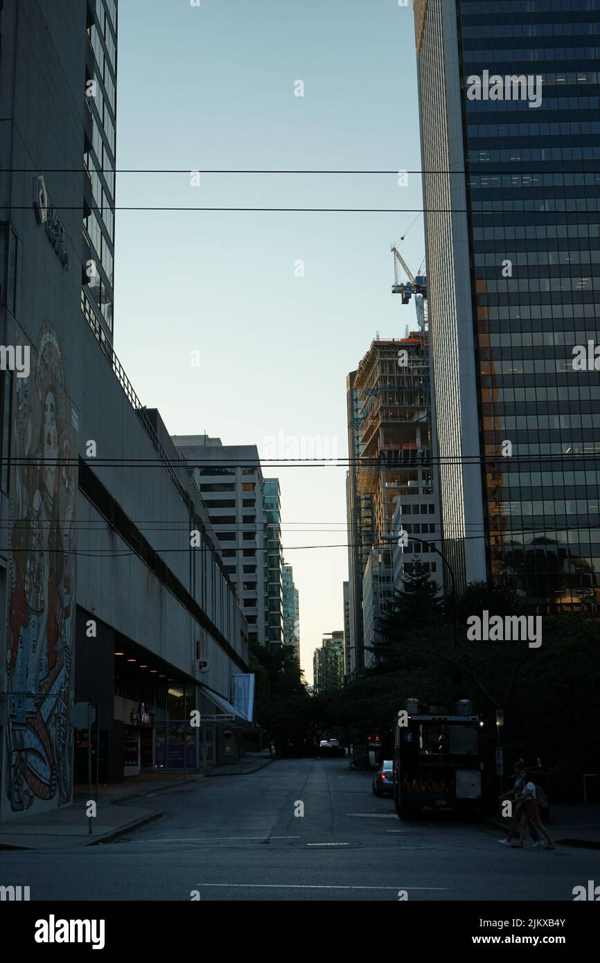 A vertical shot of tall modern buildings and a street in downtown ...