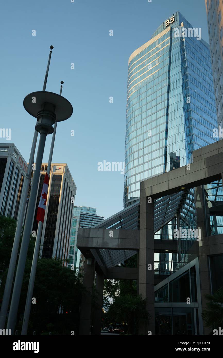 A vertical low angle view of a tall modern building with glass windows ...
