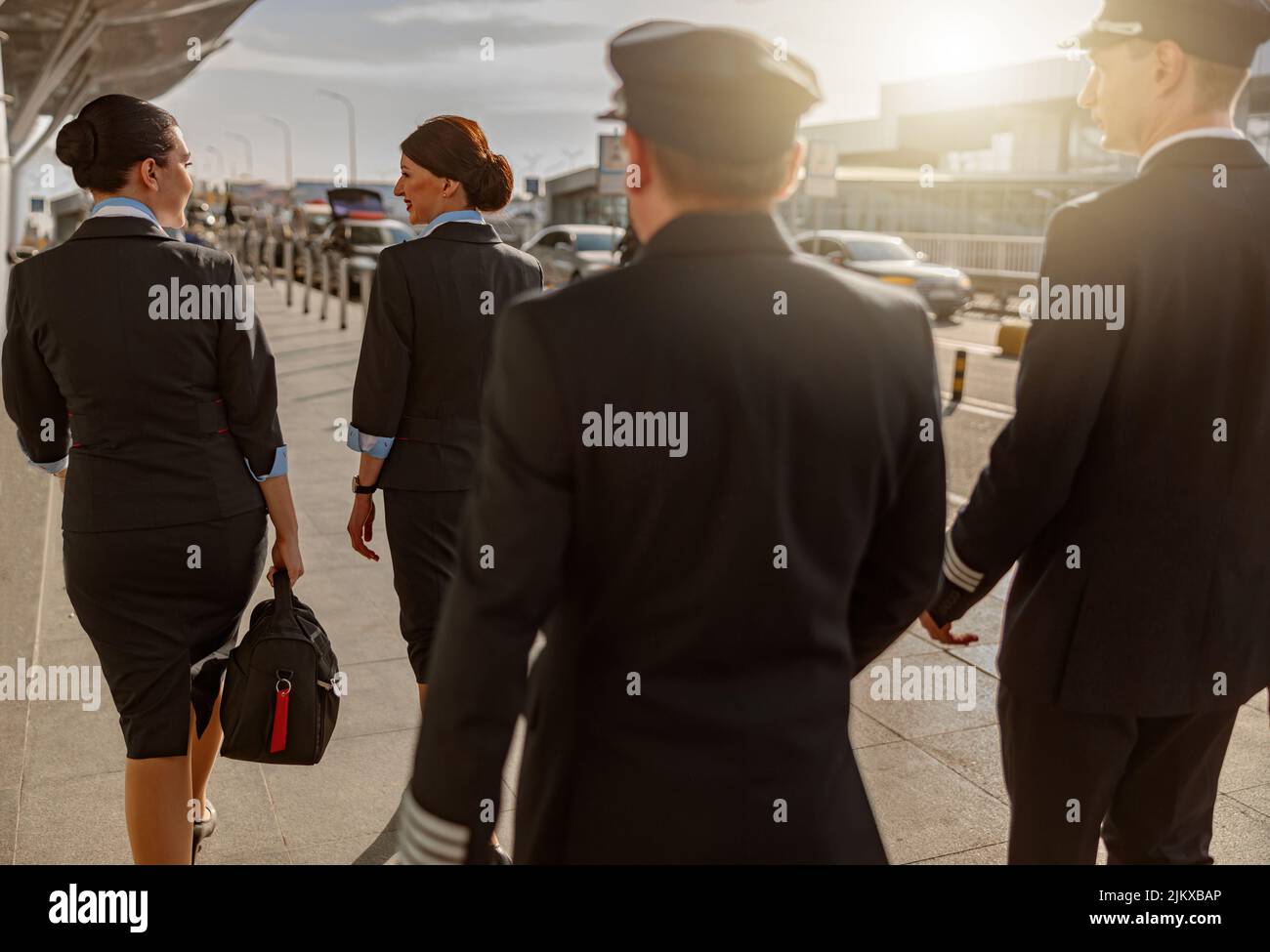 Crew of four walking near the terminal Stock Photo - Alamy