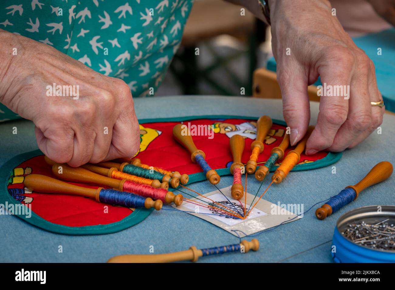 Hands of woman making bobbin lace. Colorful lace threads. Skill and ...