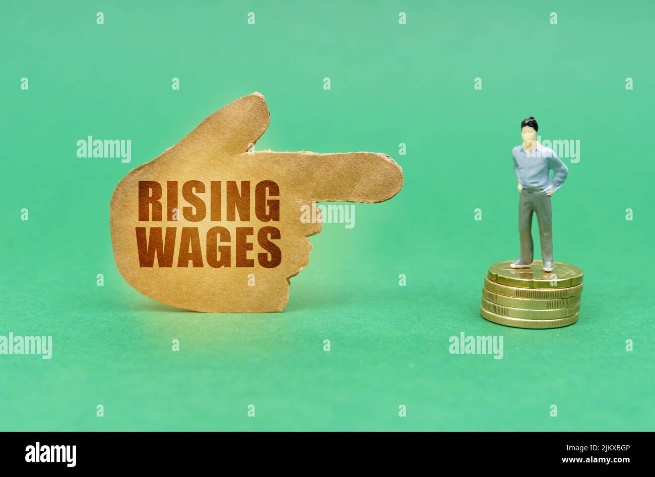 Business concept. On the green surface on the coins there is a figure ...