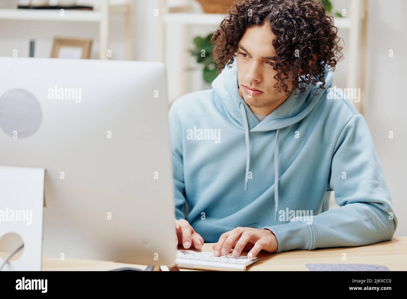 handsome guy in a blue jacket in front of a computer Lifestyle Stock ...