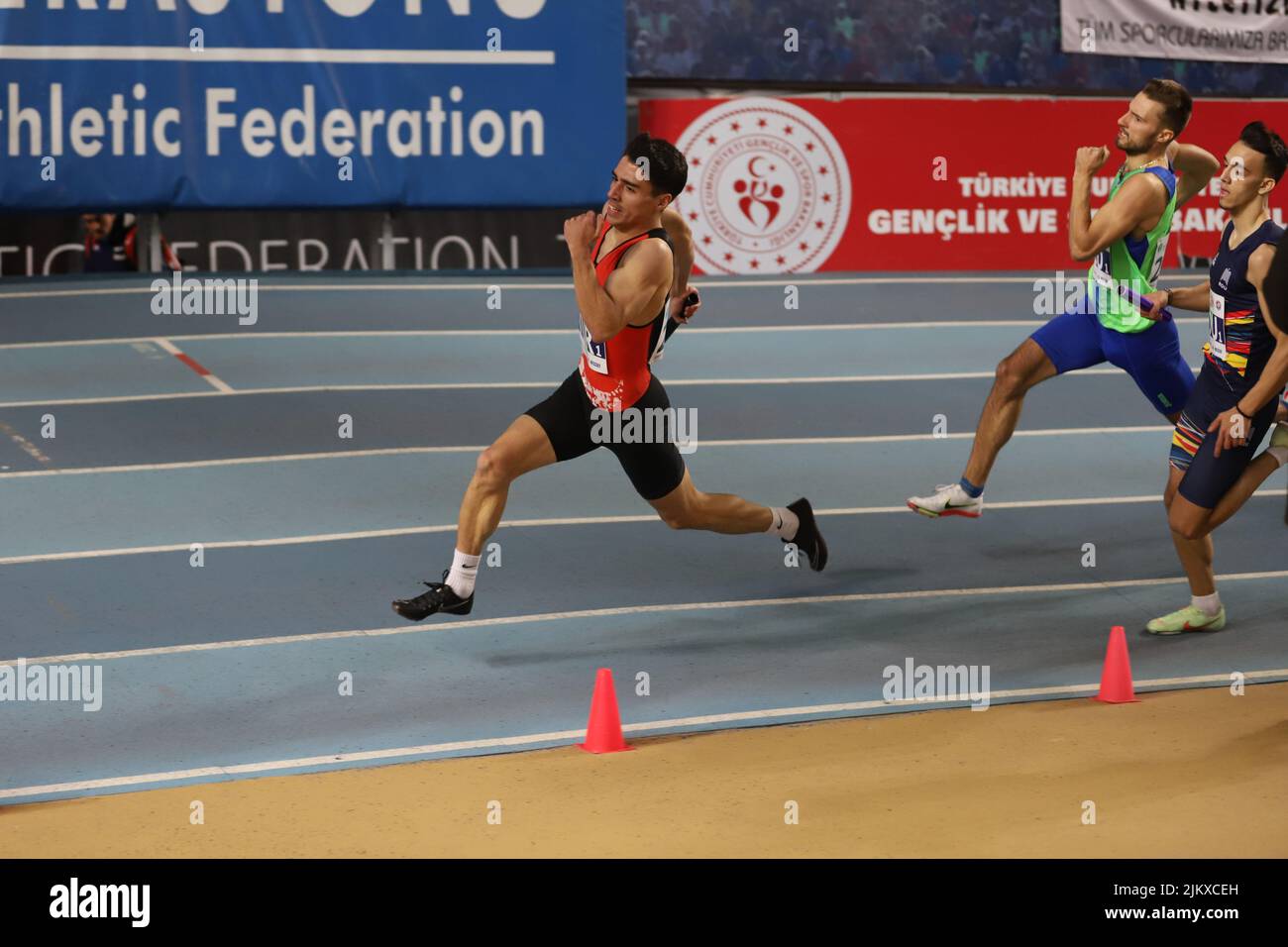 ISTANBUL, TURKEY - MARCH 05, 2022: Athletes running 4x400 metres relay ...