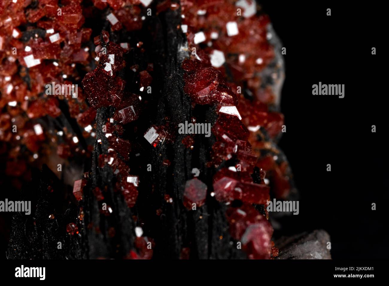 Closeup of a scarlet crystal, a beautiful rare mineral and a black background Stock Photo - Alamy