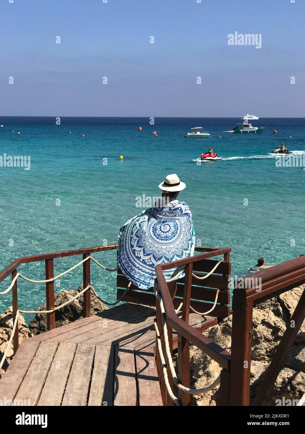 A back view of a young female on the beach Stock Photo - Alamy