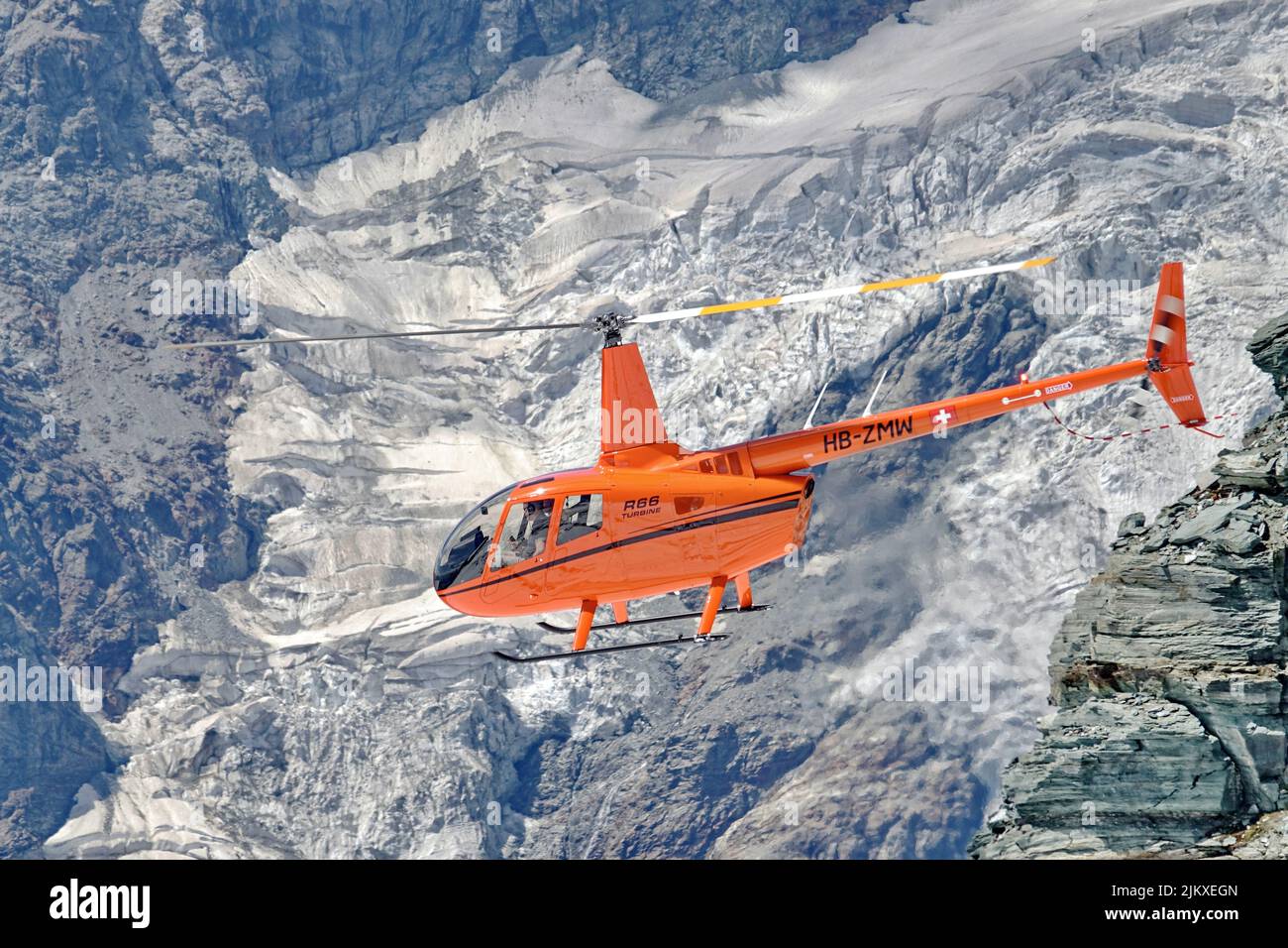 Helicopter flying in Swiss Alps mountain. Zermatt, Switzerland - August ...