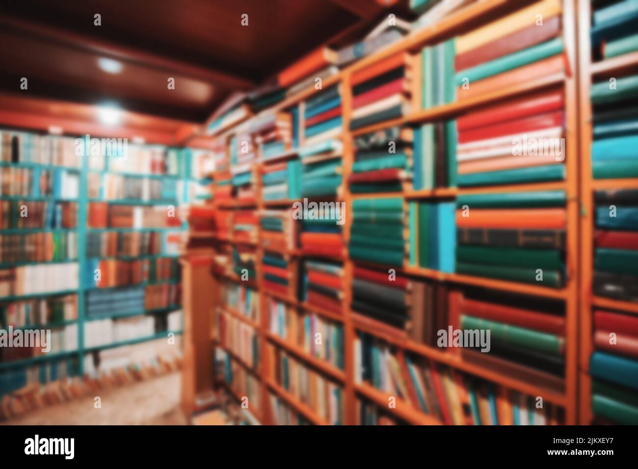 Blurred background from a library with lots of books on the shelves ...