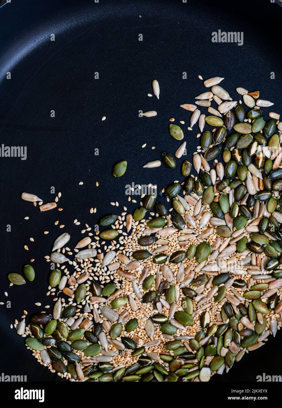 Toasted Pumpkin, Sunflower and Sesame Seeds in frying pan Stock Photo ...