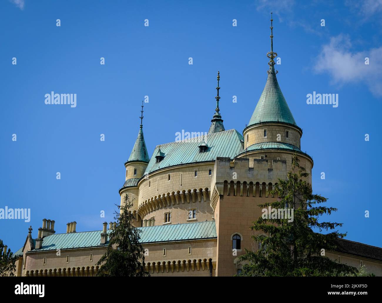 The Bojnice Castle with blue domes against the blue sky in Slovakia ...