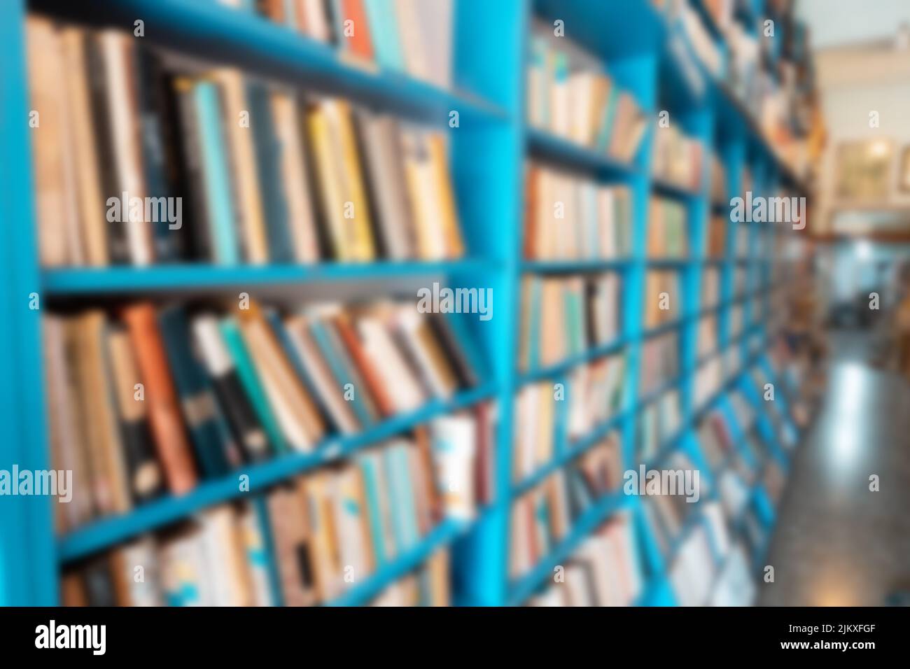 Blurred background from a library with lots of books on the shelves ...