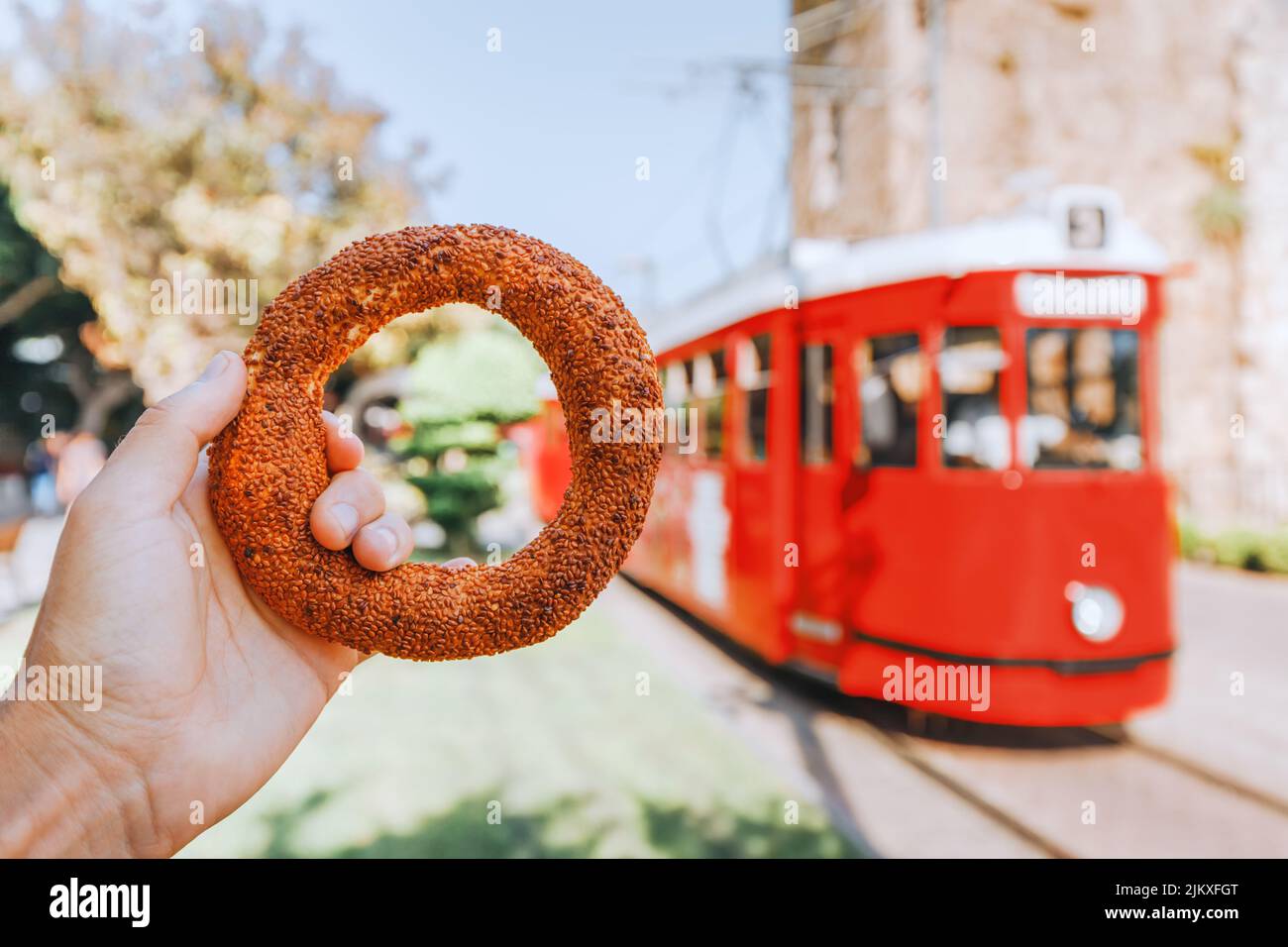 Traditional simit bagel street food snack at the background of red ...