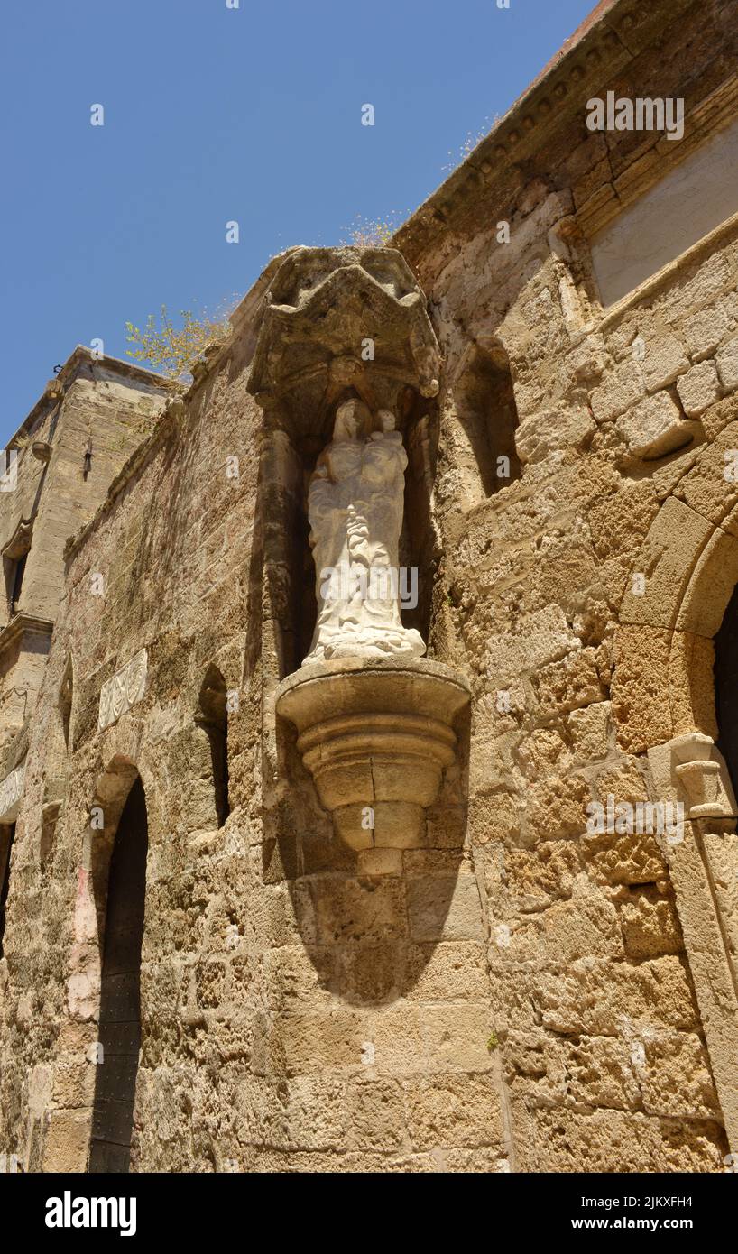 Figure of Maria and her child on a wall historical building in Rhodes ...