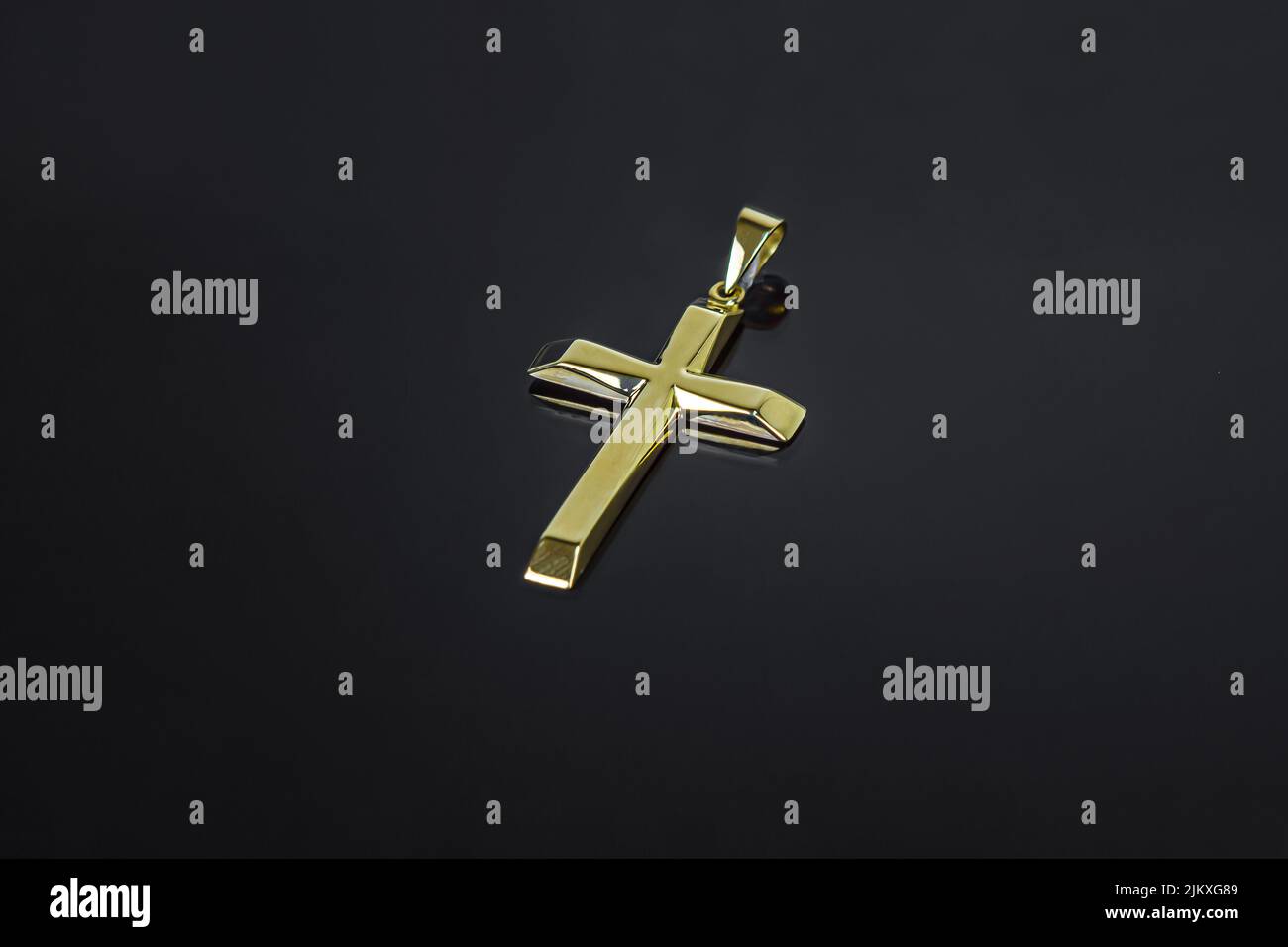 A closeup of a golden cross on the black background Stock Photo - Alamy