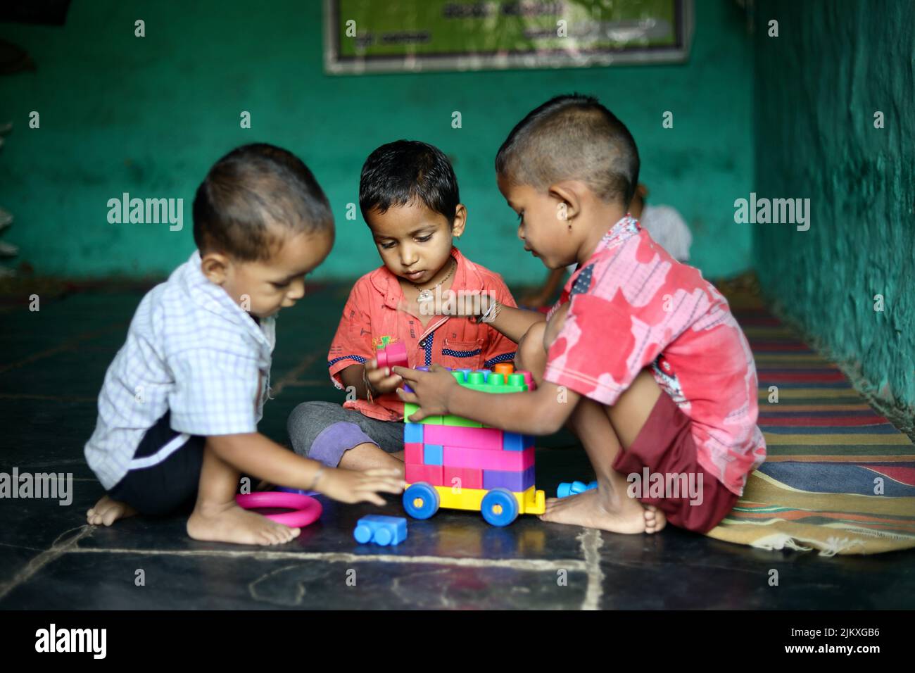 A selective focus of face of a south Indian village kid playing with ...