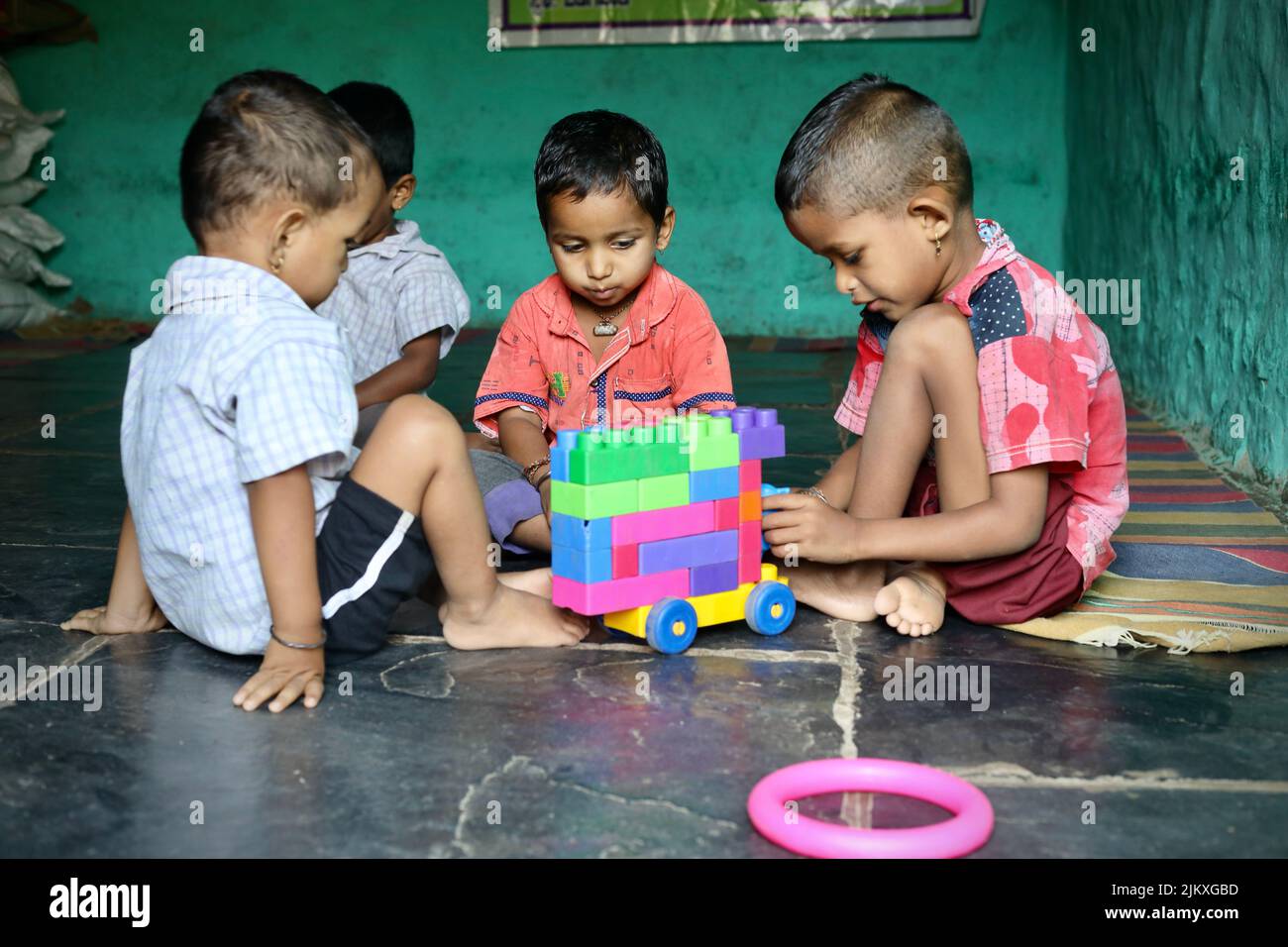 A selective focus of face of a south Indian village kid playing with ...