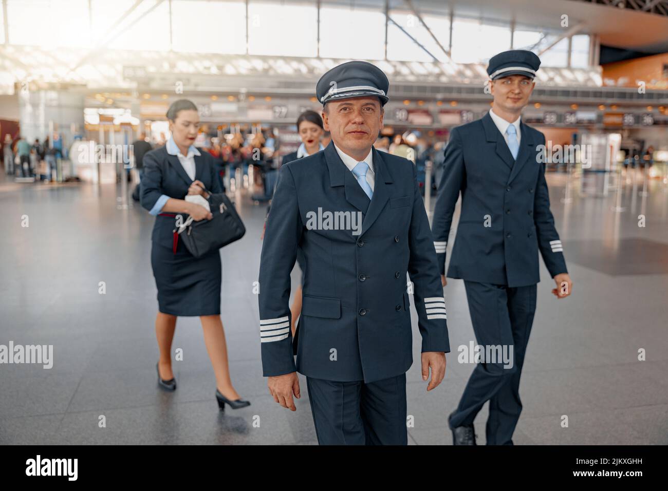 Pilot flight attendants walking airport hi-res stock photography and ...