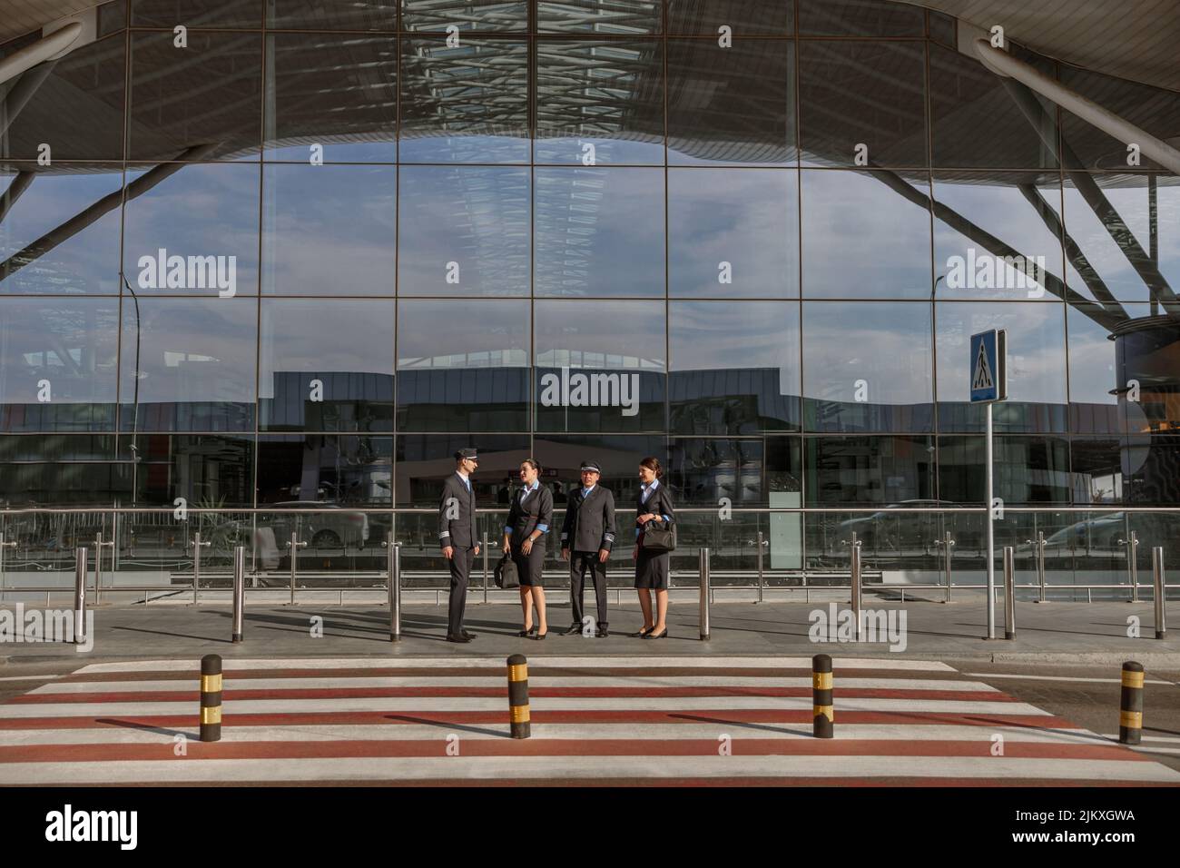 Flight team standing outdoor with terminal on the background Stock ...