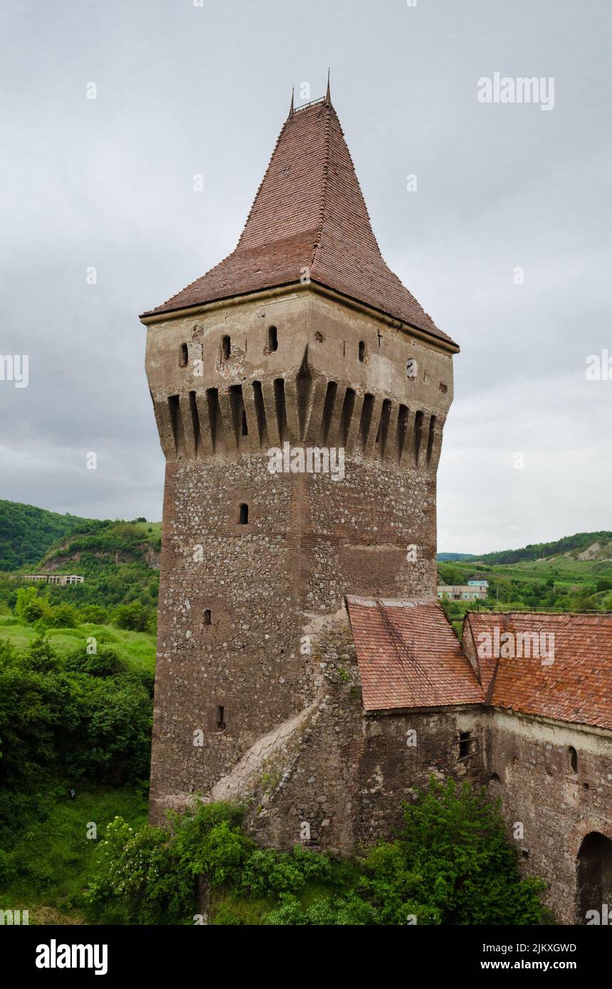 A vertical shot of Corvin Castle tower, also known as Hunyadi Castle or ...