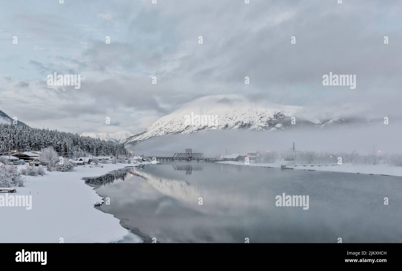 Village of Carcross, Yukon in January with ice fog over Bennett Lake ...