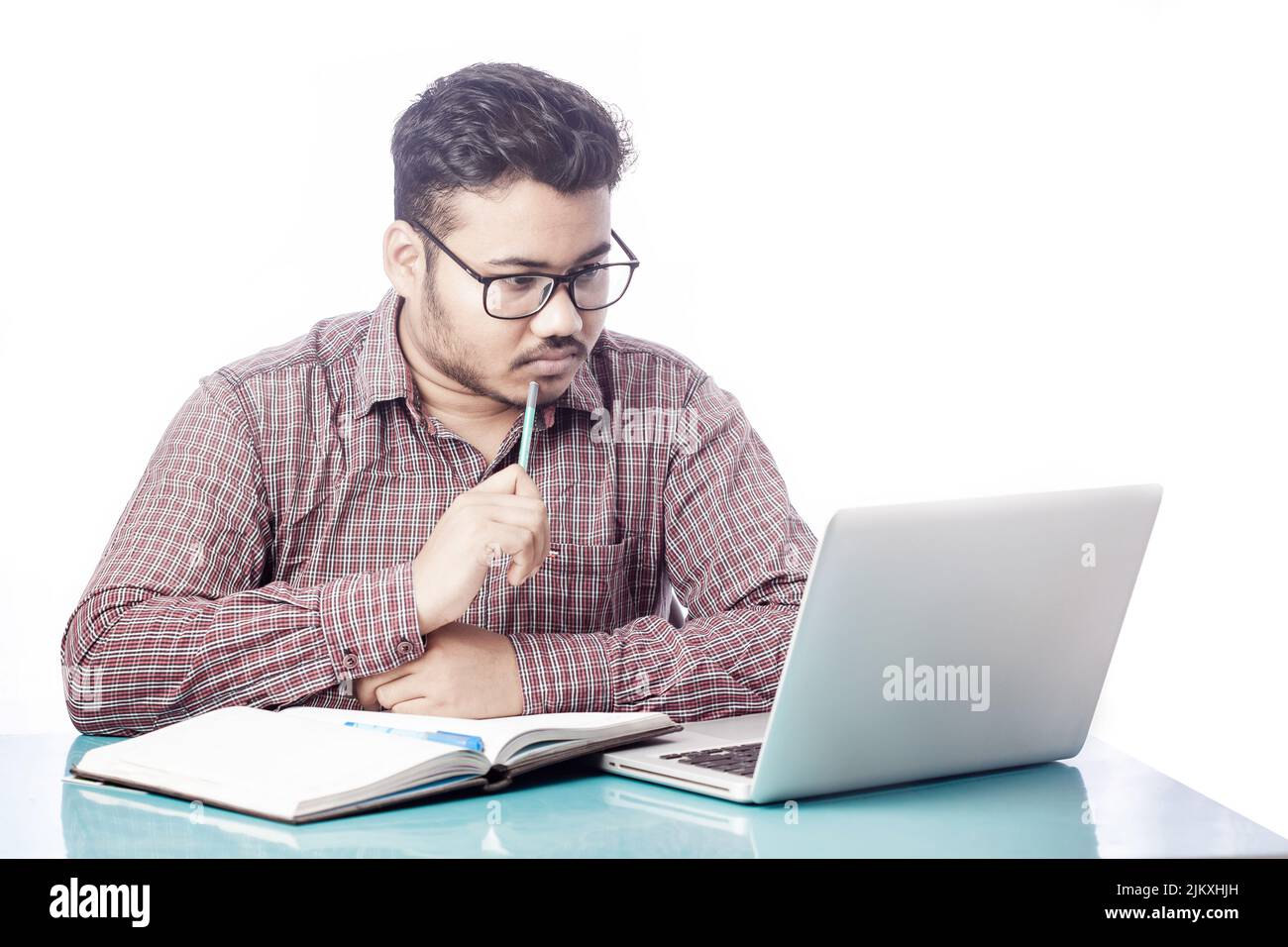 student thinking with pencil on mouth looking at computer screen on a ...