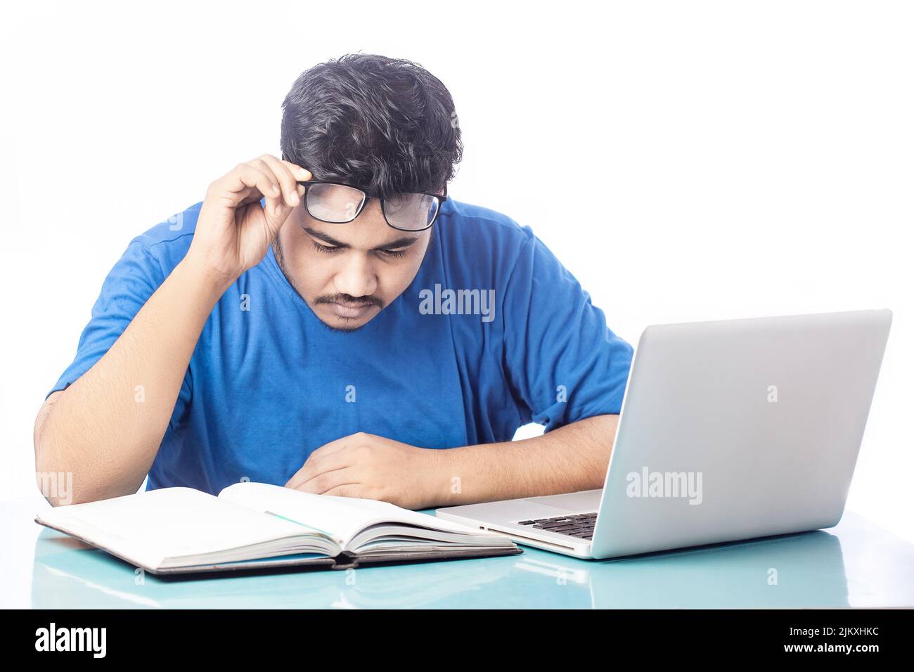 Casual Man Lift Eyeglass And Reading On Diary Notebook Working On