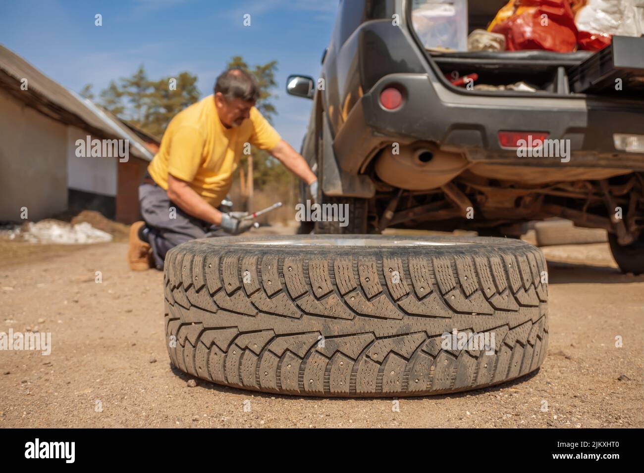 Replacing a spare wheel on the road with your own hands. The driver ...