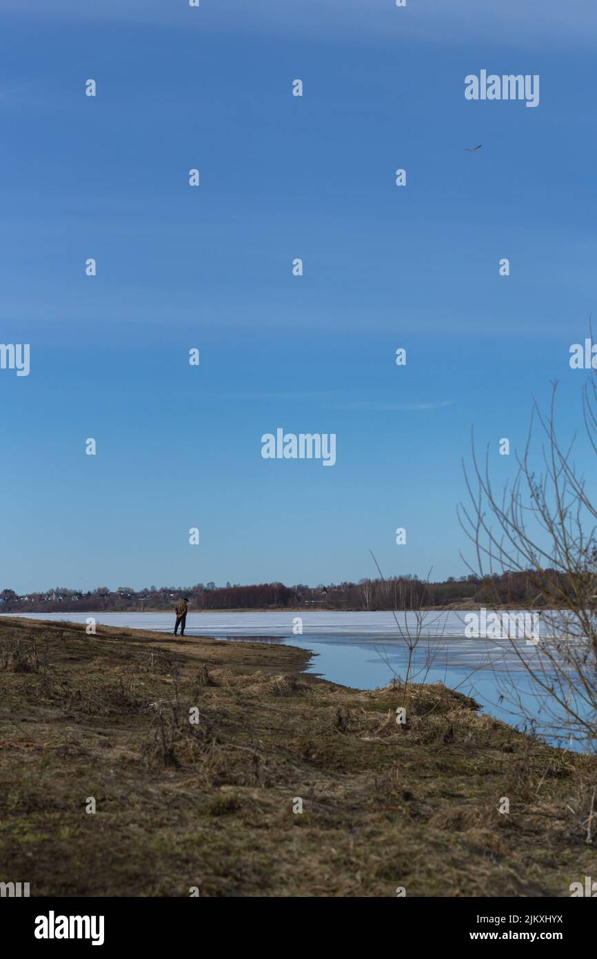 beautiful place, unknown man looking at nothing in a lake Stock Photo ...